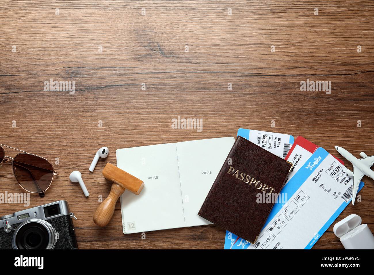 Flat lay composition with passports, stamp and flight tickets on wooden ...