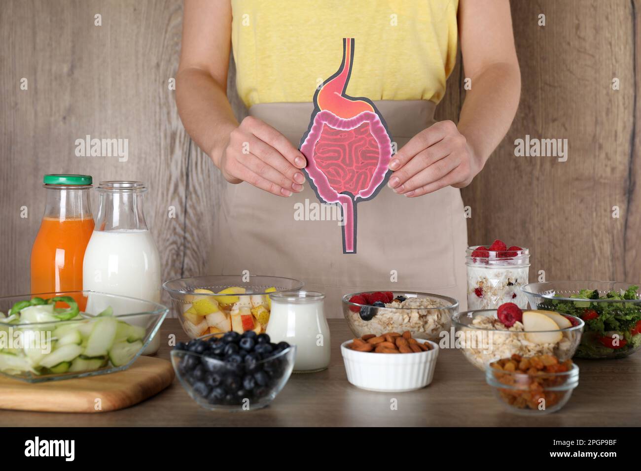 Woman holding paper intestine near table with food, closeup. Balanced ...