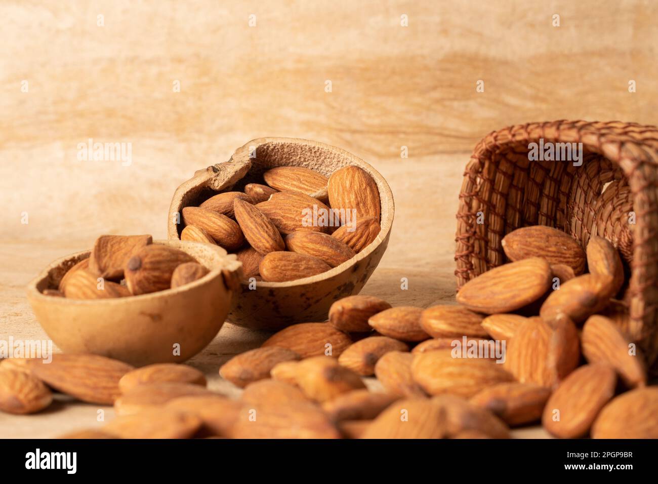 Shelled almonds in rustic containers. Amate paper background Stock ...