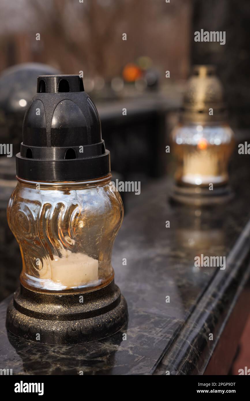 Grave lantern with candle on granite surface at cemetery Stock Photo - Alamy