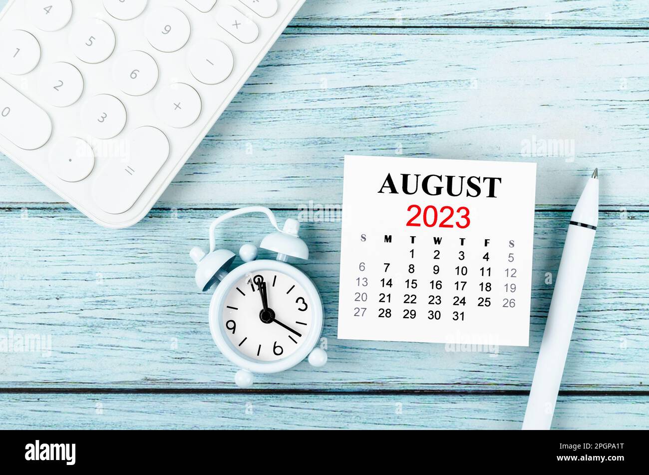 August 2023 Monthly calendar year and alarm clock with calculator on ...