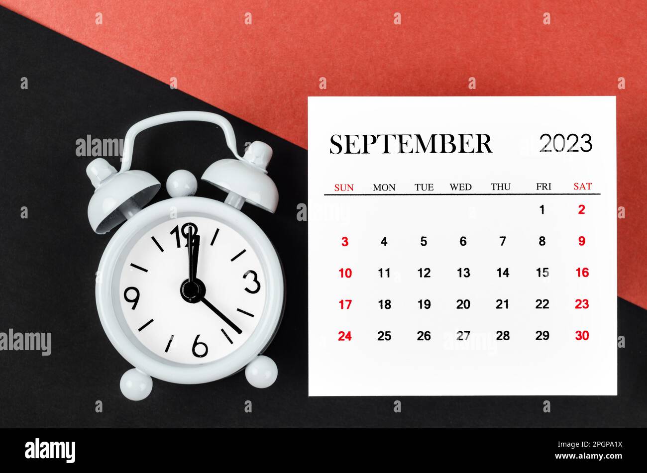 September 2023 Monthly calendar year with alarm clock on red and black ...