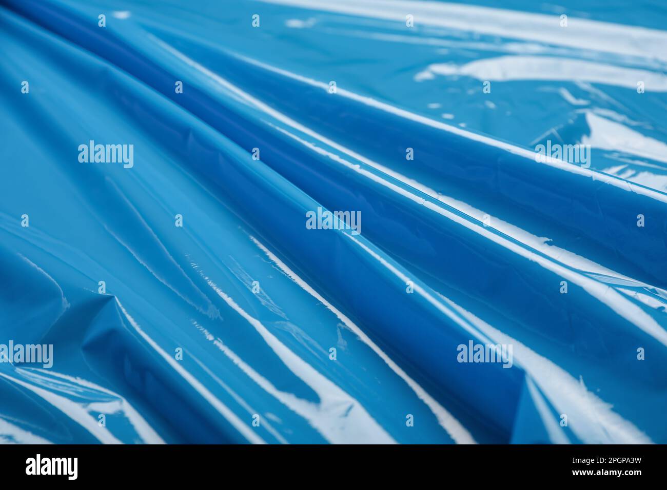 Closeup view of light blue plastic stretch wrap film as background ...