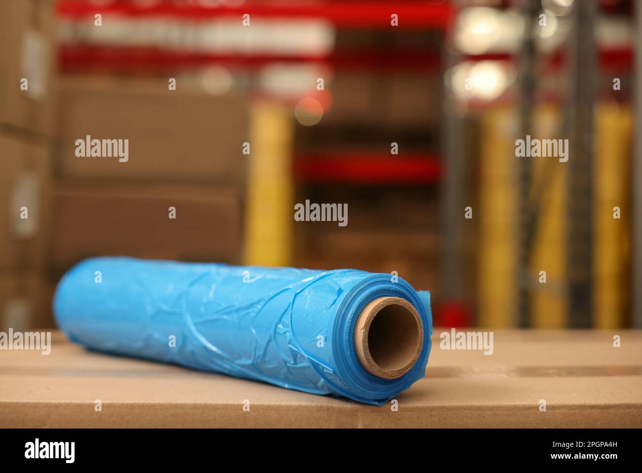 Roll of stretch wrap on boxes in warehouse Stock Photo - Alamy