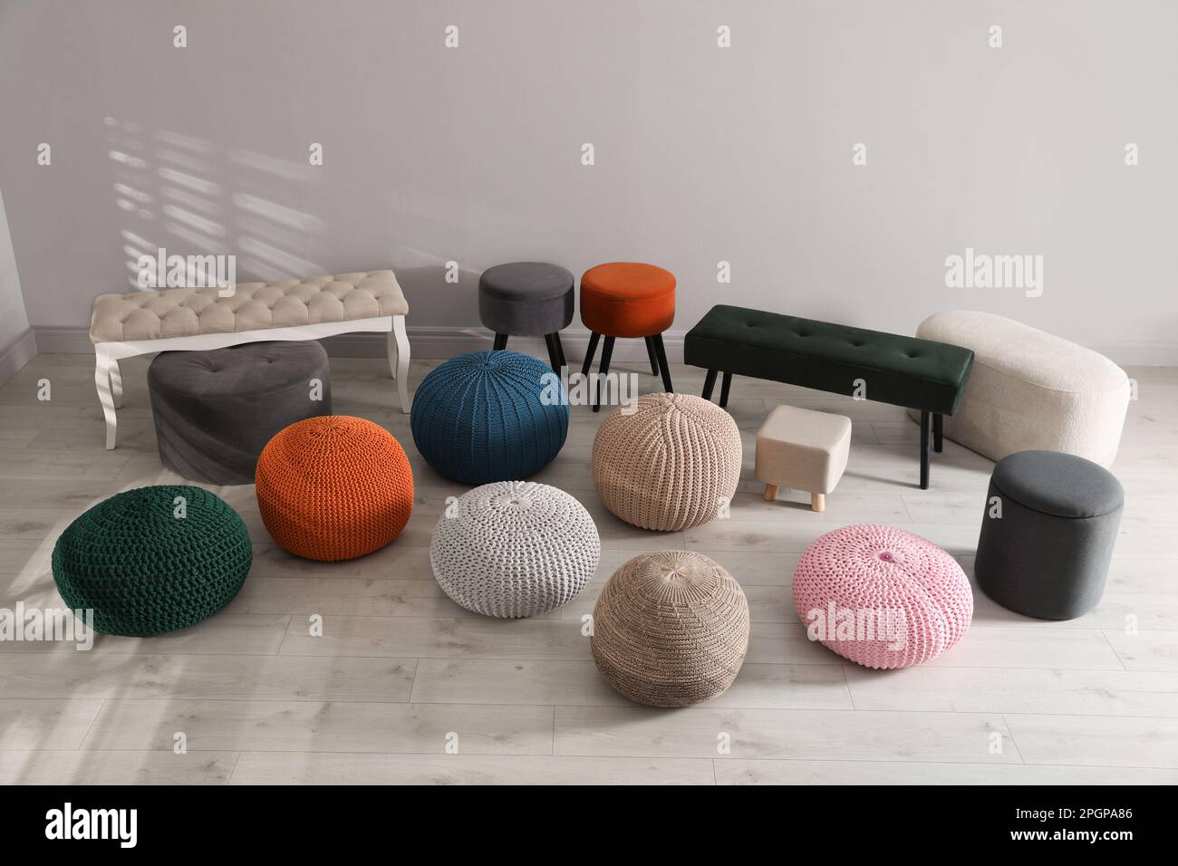 Many stylish different poufs and benches indoors. Home design Stock ...
