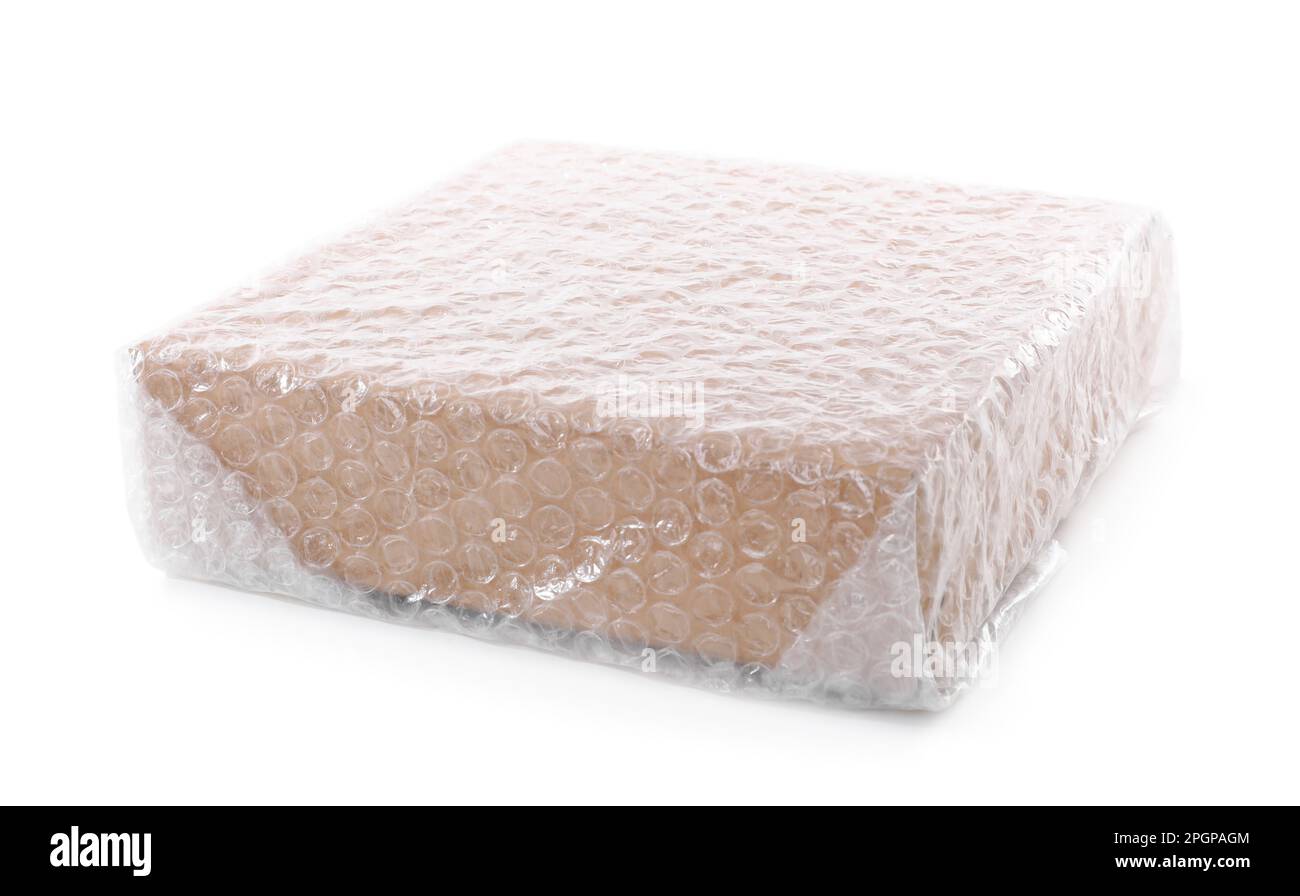 Cardboard box packed in bubble wrap isolated on white Stock Photo - Alamy