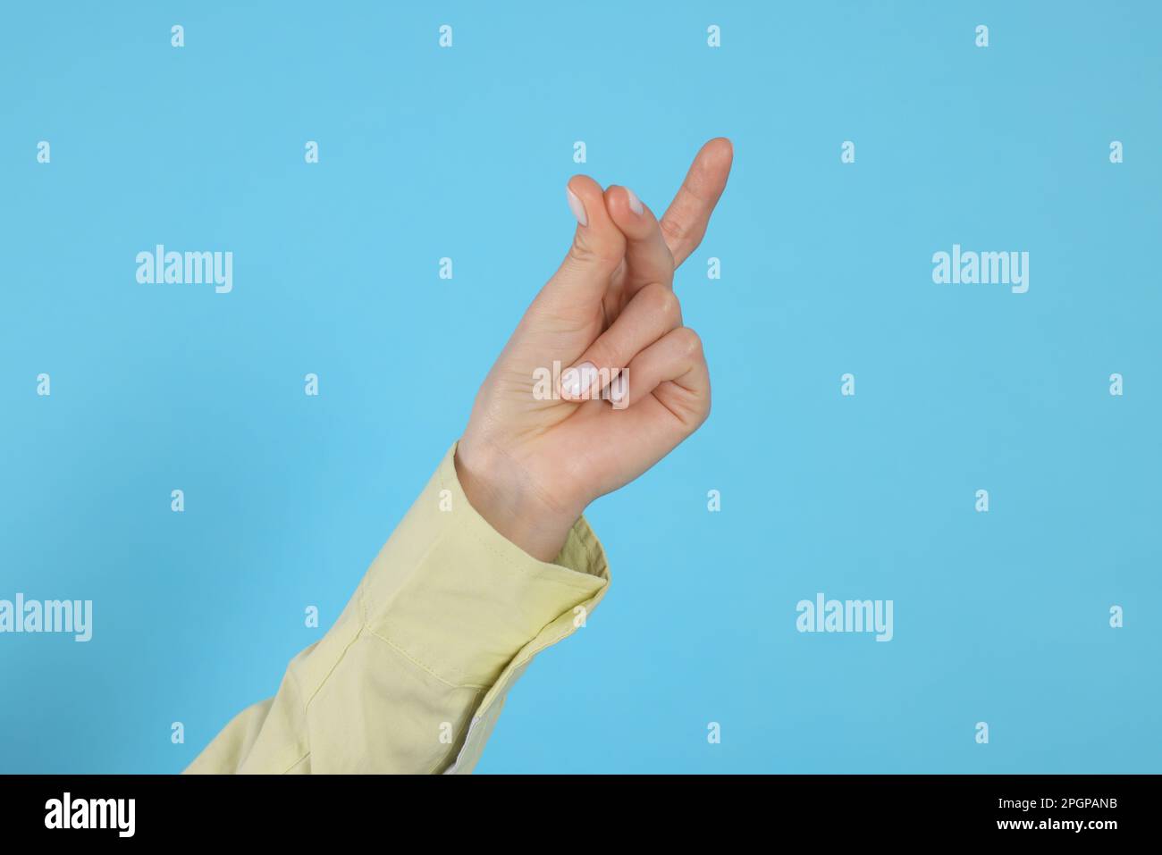 Woman snapping fingers on light blue background, closeup of hand Stock ...