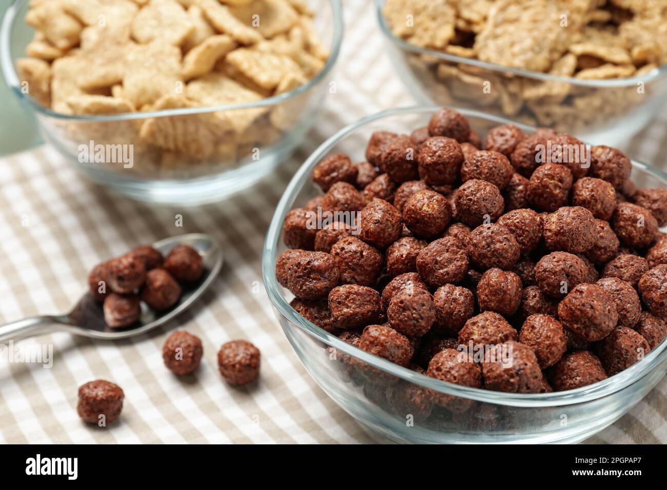 Different delicious breakfast cereals on kitchen towel, closeup Stock ...