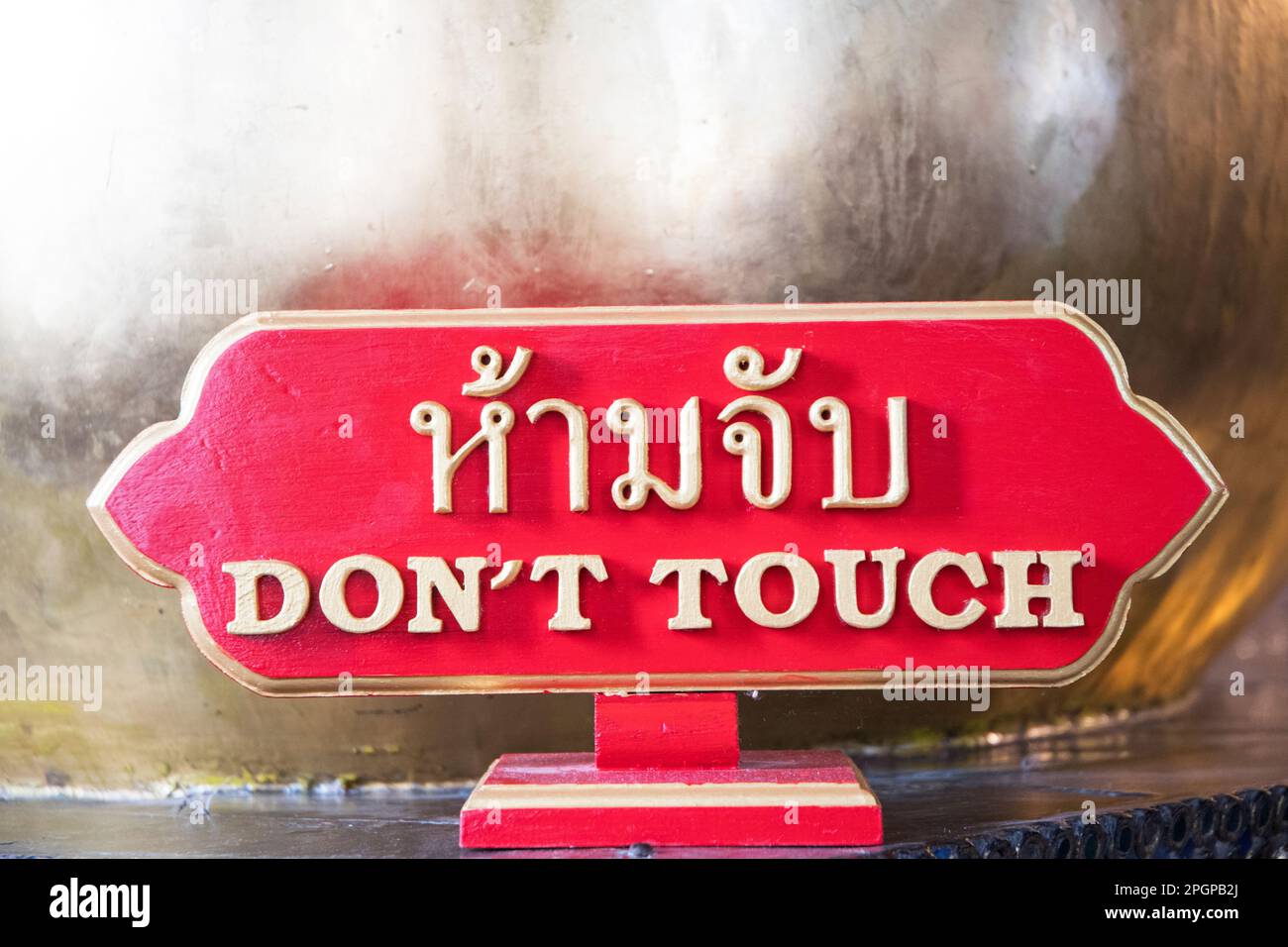 Thai and English language warning symbol word with don't touch on red ...