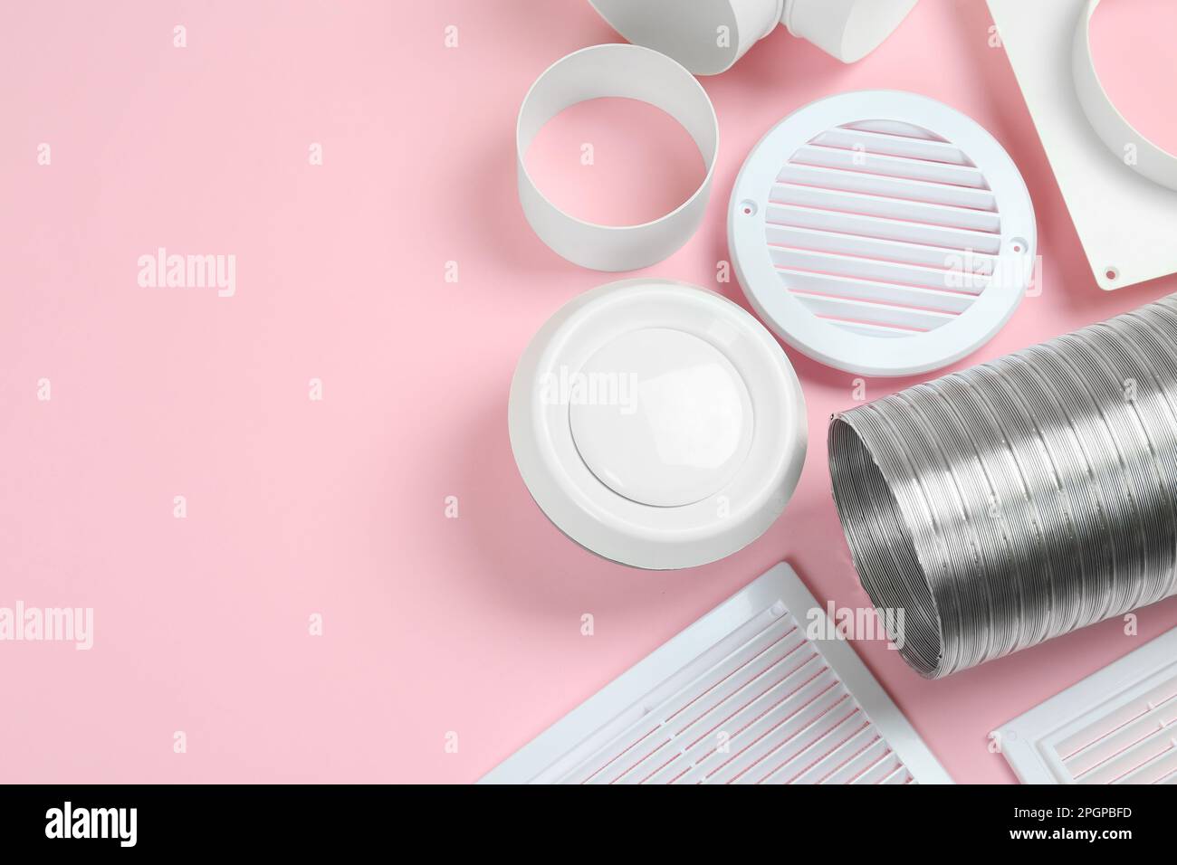 Parts of home ventilation system on pink background, above view. Space ...