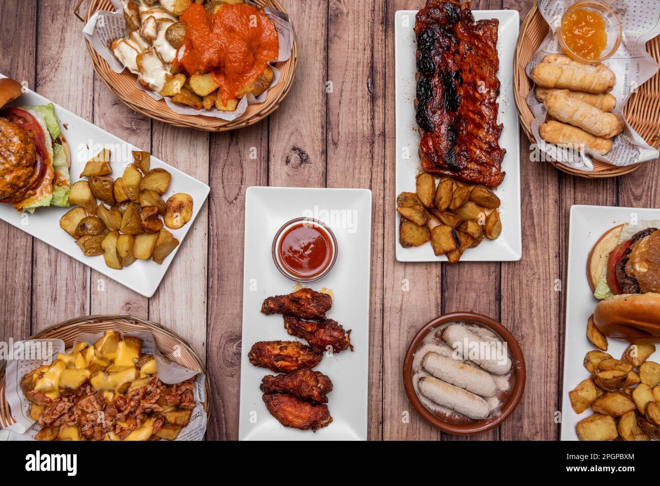 Set of international fast food dishes, barbecue ribs, burgers, patatas ...