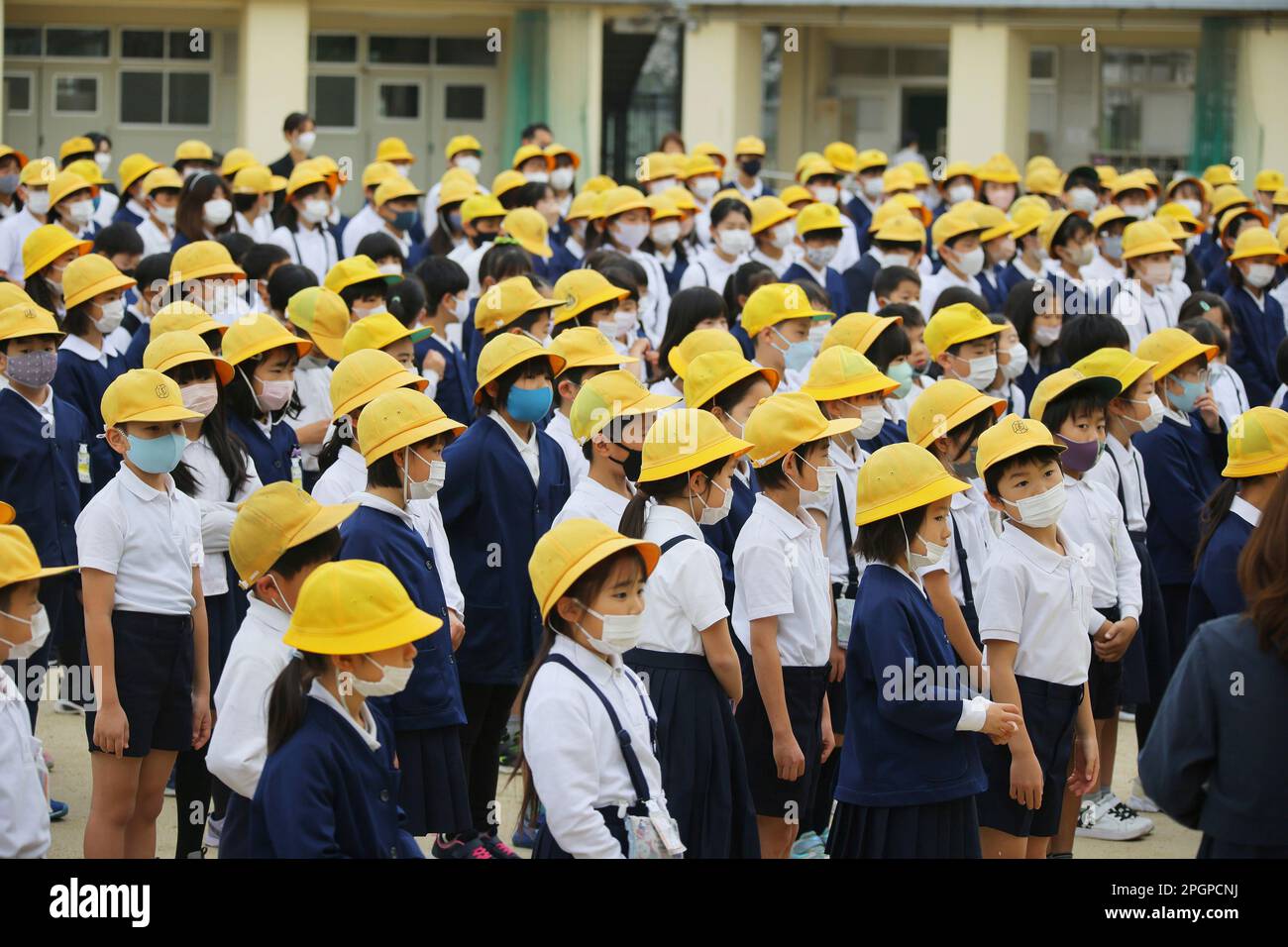 Students attend a closing ceremony in a playground at the municipal Sumire Elementary School in ...