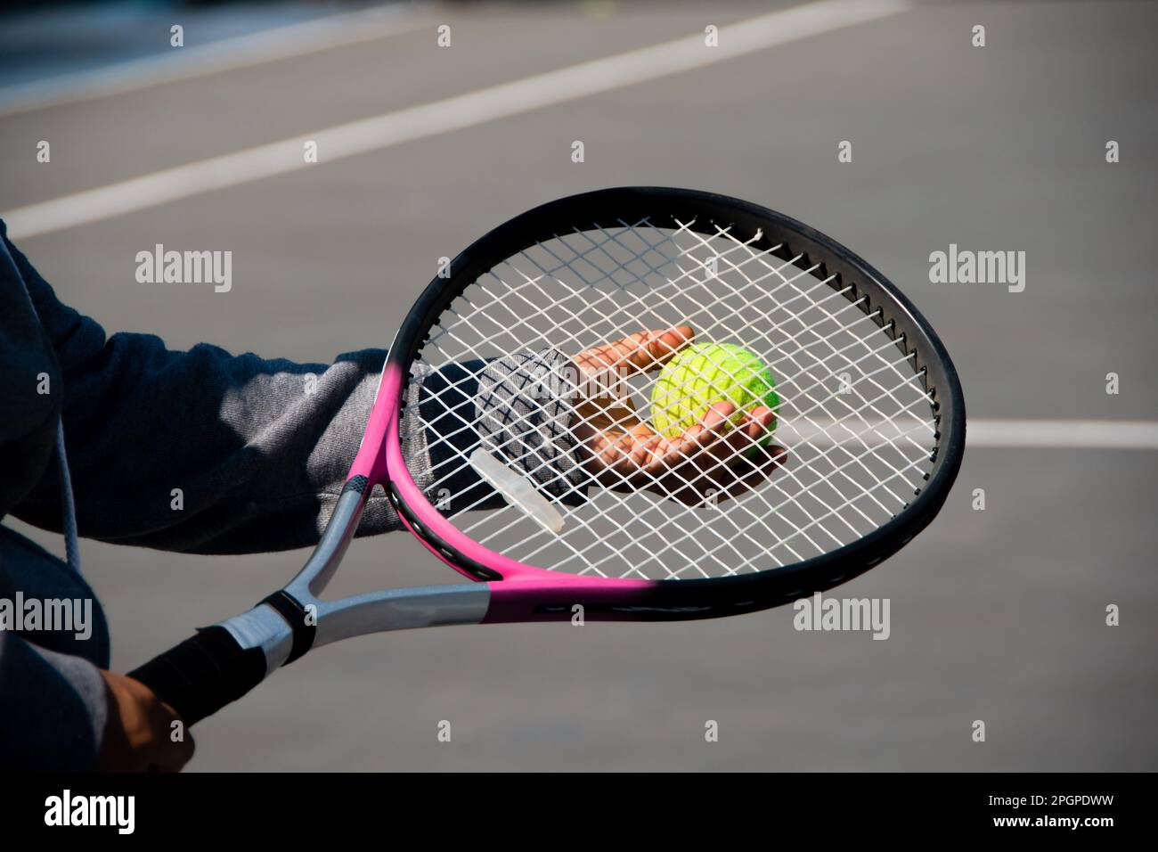 someone holding tennis ball and racket Stock Photo - Alamy