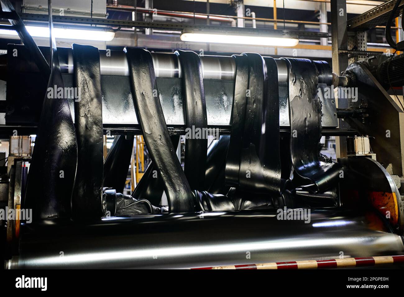 Rubber strips on metal rollers at compound calendering Stock Photo - Alamy