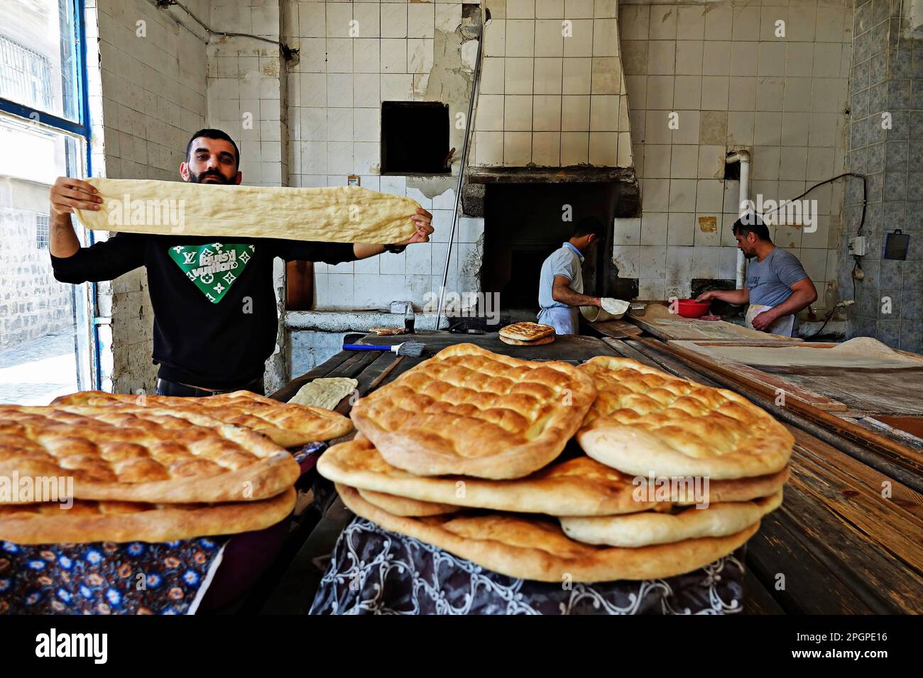 Ferhat Erzem is seen showing the lavash breads that were baked and ...