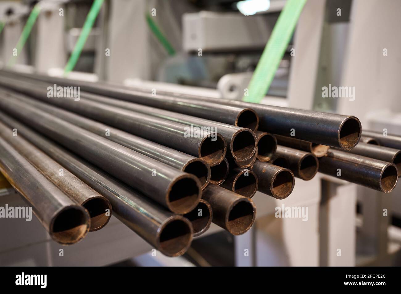 Stack of long metal pipes in metalworking plant warehouse Stock Photo ...