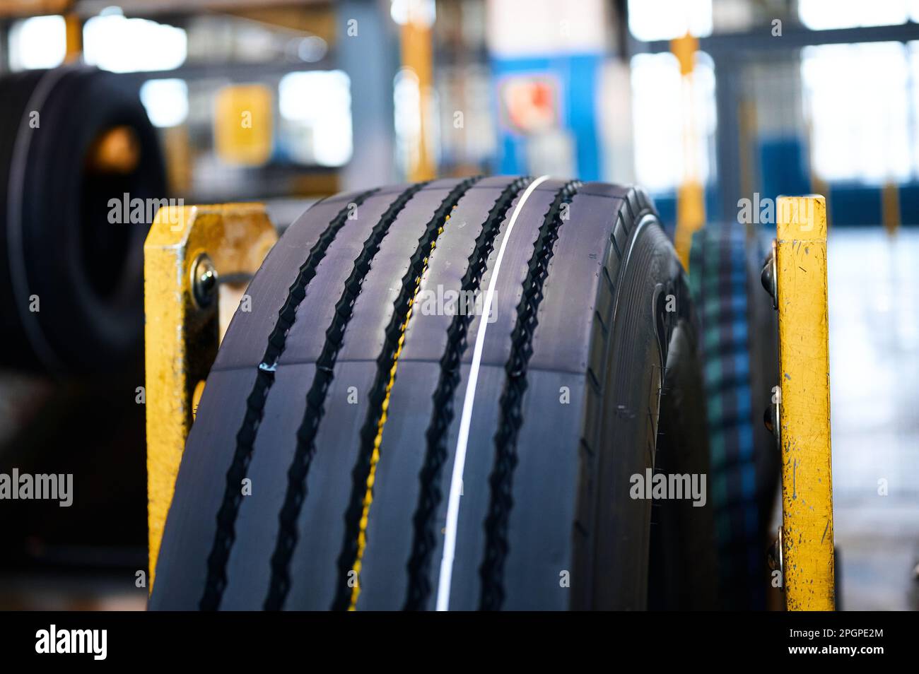 Finished tire with yellow and white color lines on rod at factory Stock ...