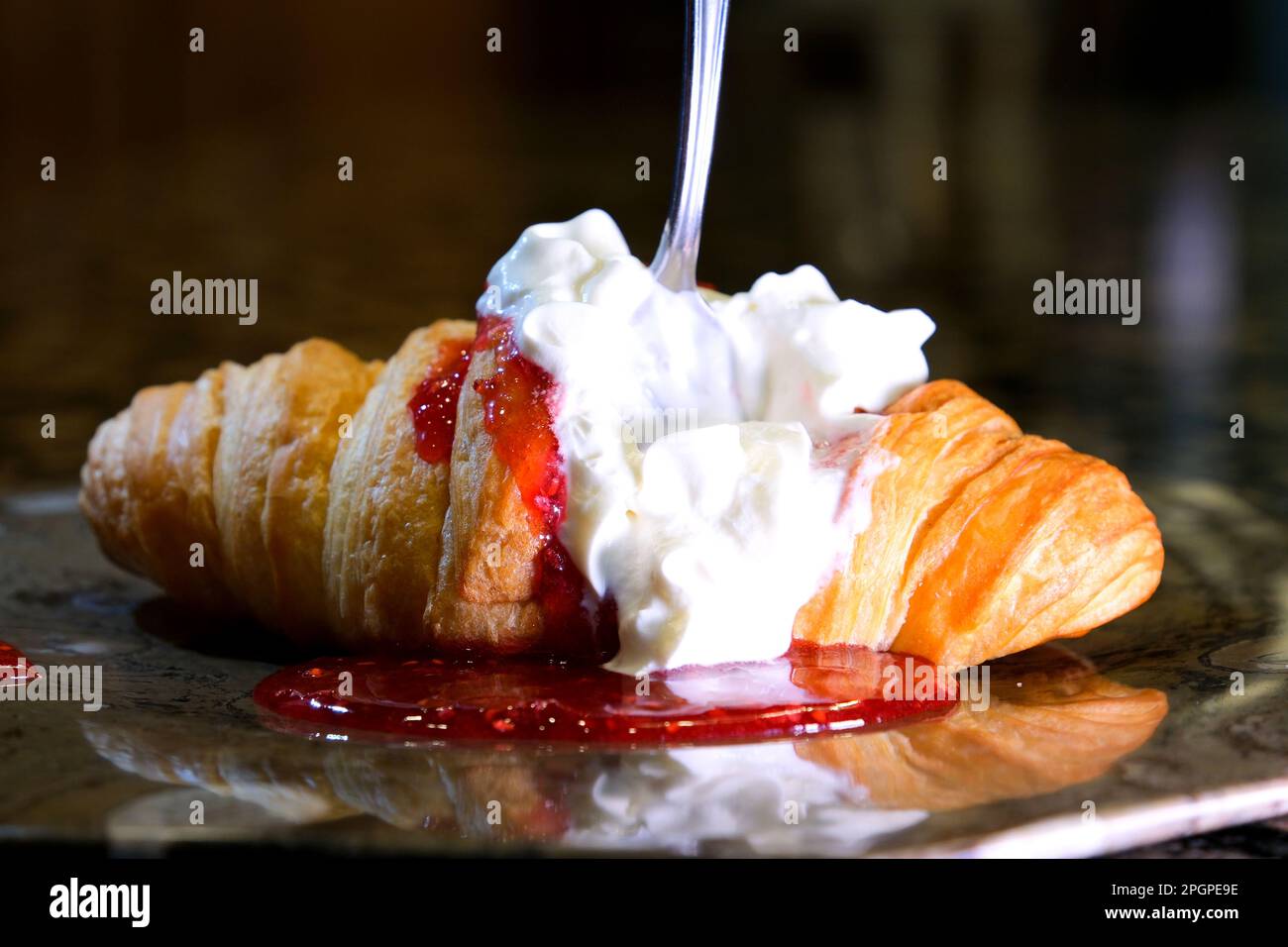 croissant with raspberry jam on stone plate top pour cream airy white ...