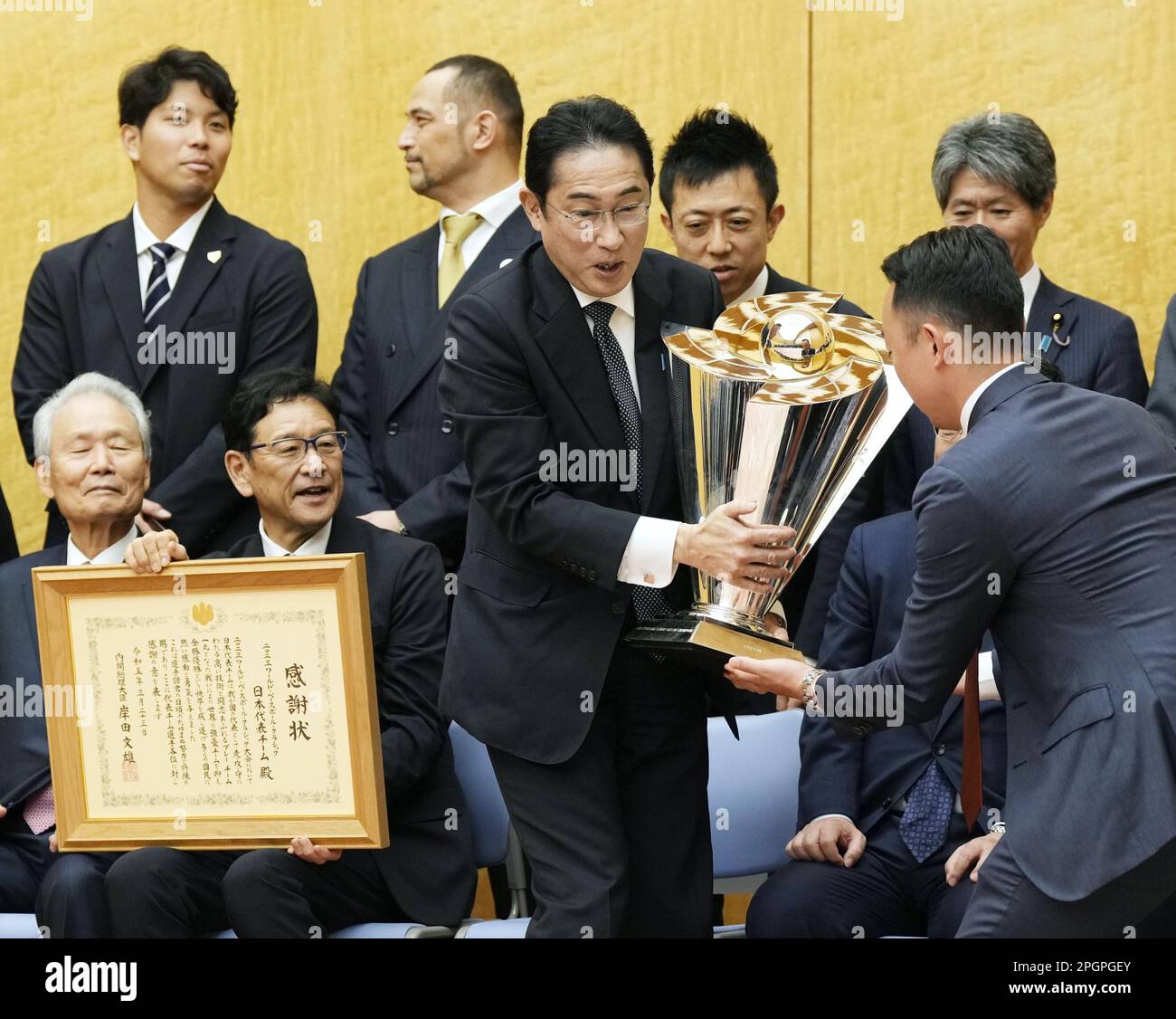 Japanese Prime Minister Fumio Kishida (C) holds the World Baseball ...