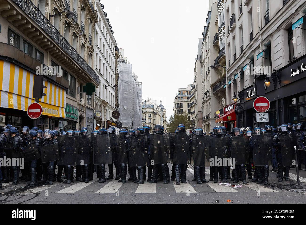 Paris, France. 23rd Mar, 2023. Riot police wait in formation for ...