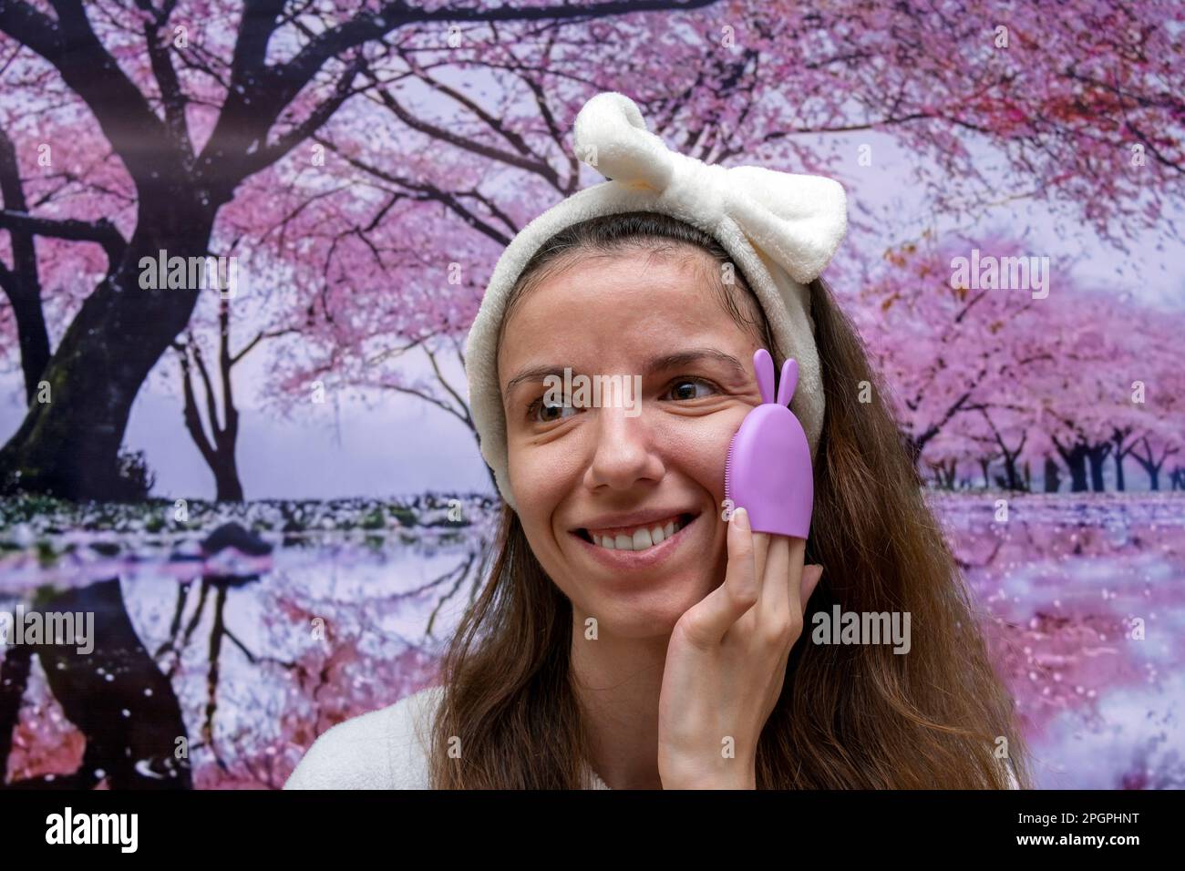 Attractive model using a face scrub made of silicon Stock Photo - Alamy