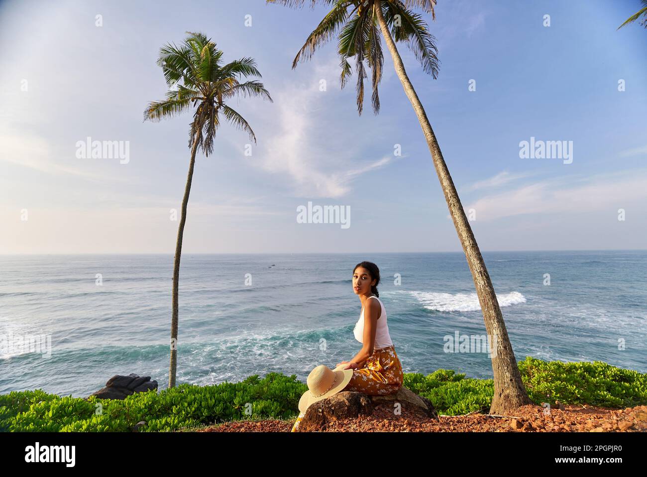 Young african female model posing in colorful clothes at scenic ...
