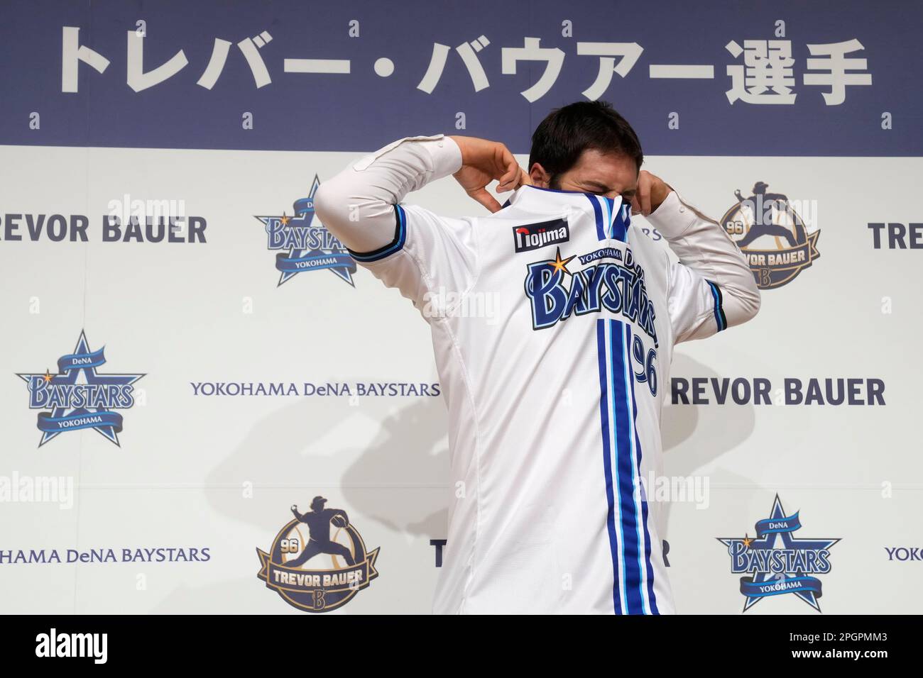 Trevor Bauer puts on his new uniform of Yokohama DeNA BayStars during a photo session of the ...