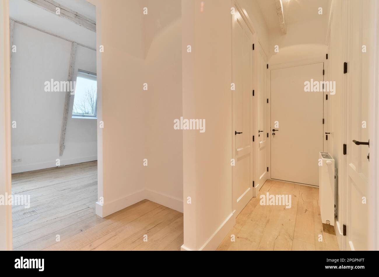 an empty room with white walls and wood flooring on the left side of ...