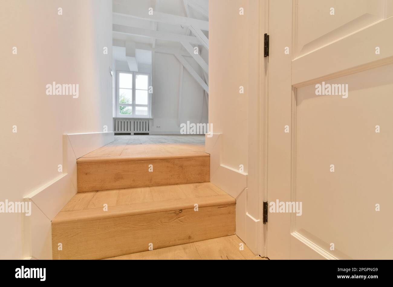 a wooden staircase leading to the first floor in a home with white ...
