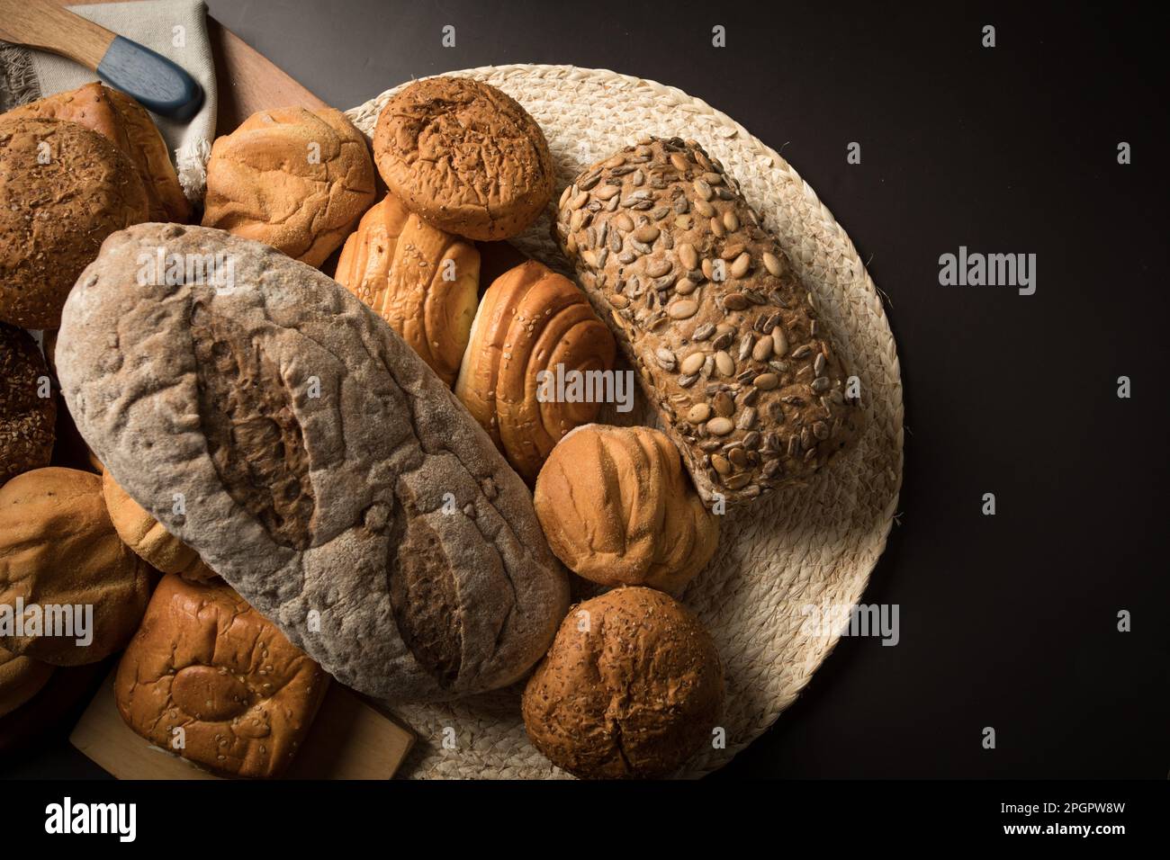 Assorted types of Loafes of bread on a table Stock Photo - Alamy