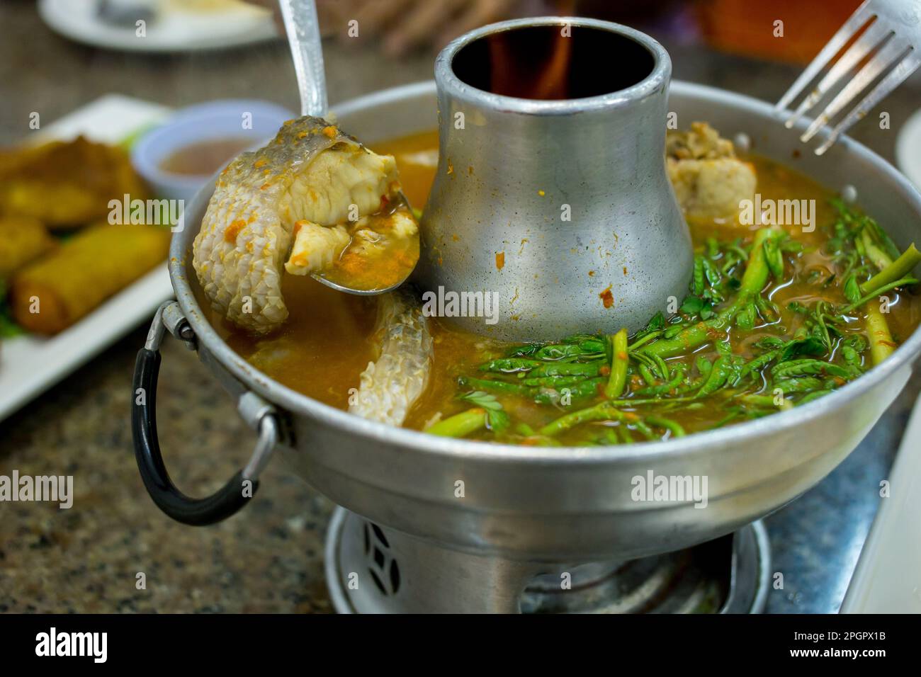 Fire dish and striped snakehead fish curry with vegetable on the fish ...