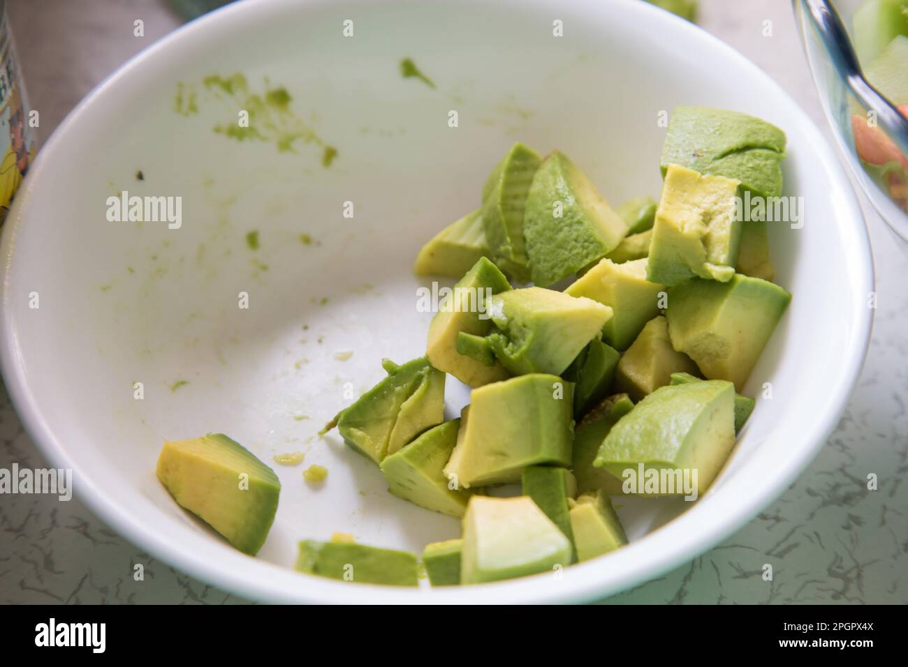 Diced ripe green avocado ingredient for salad Stock Photo - Alamy