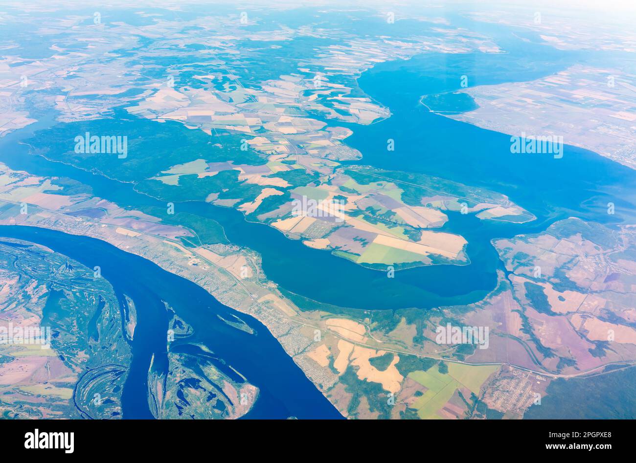 Aerial view from airplane window above green ground. View from the ...