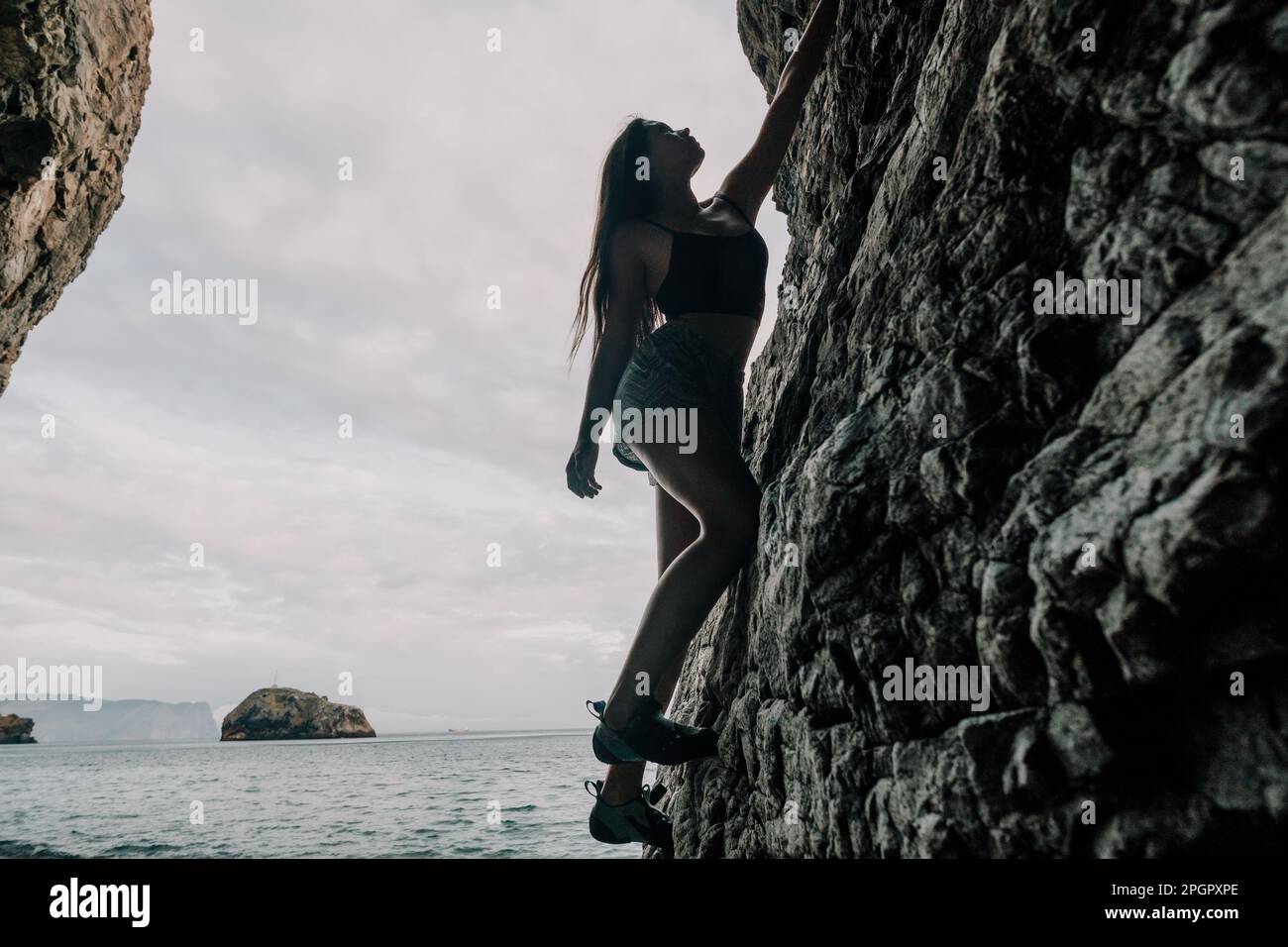 Sports Woman Climbing The Rock. Young woman With slim fit body climbing ...