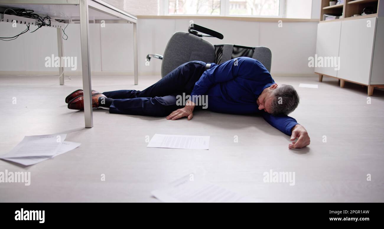 Faint Accident In Office. Fall From Chair At Workplace Stock Photo - Alamy