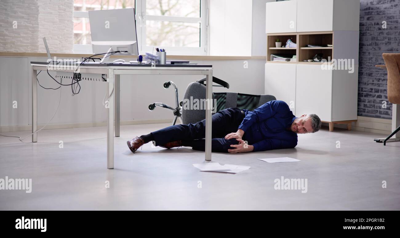 Faint Accident In Office. Fall From Chair At Workplace Stock Photo - Alamy