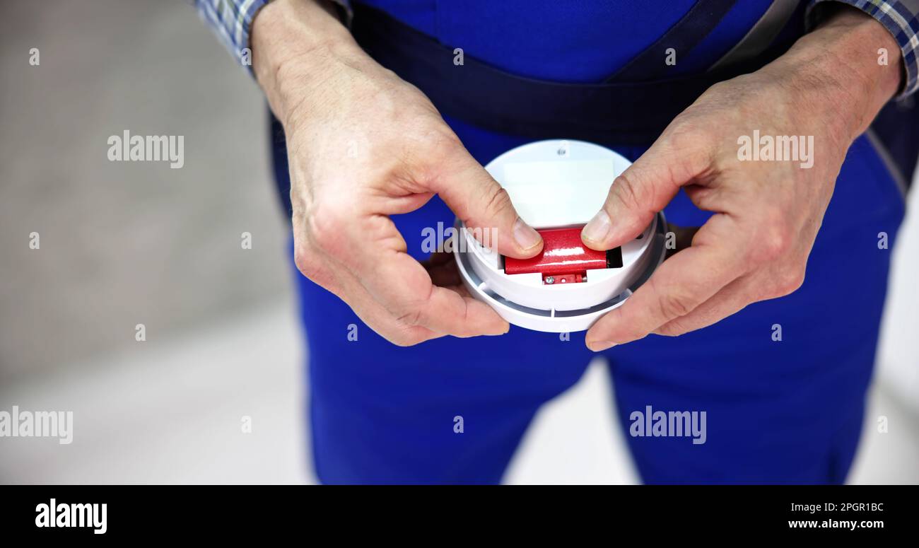 Smoke Detector Fire Alarm Battery Change By Technician Stock Photo - Alamy