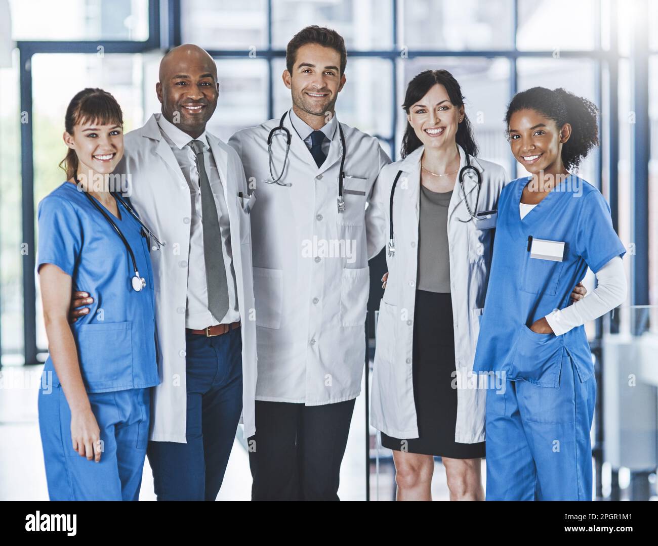 Everyday were doctoring. Portrait of a diverse team of doctors standing ...