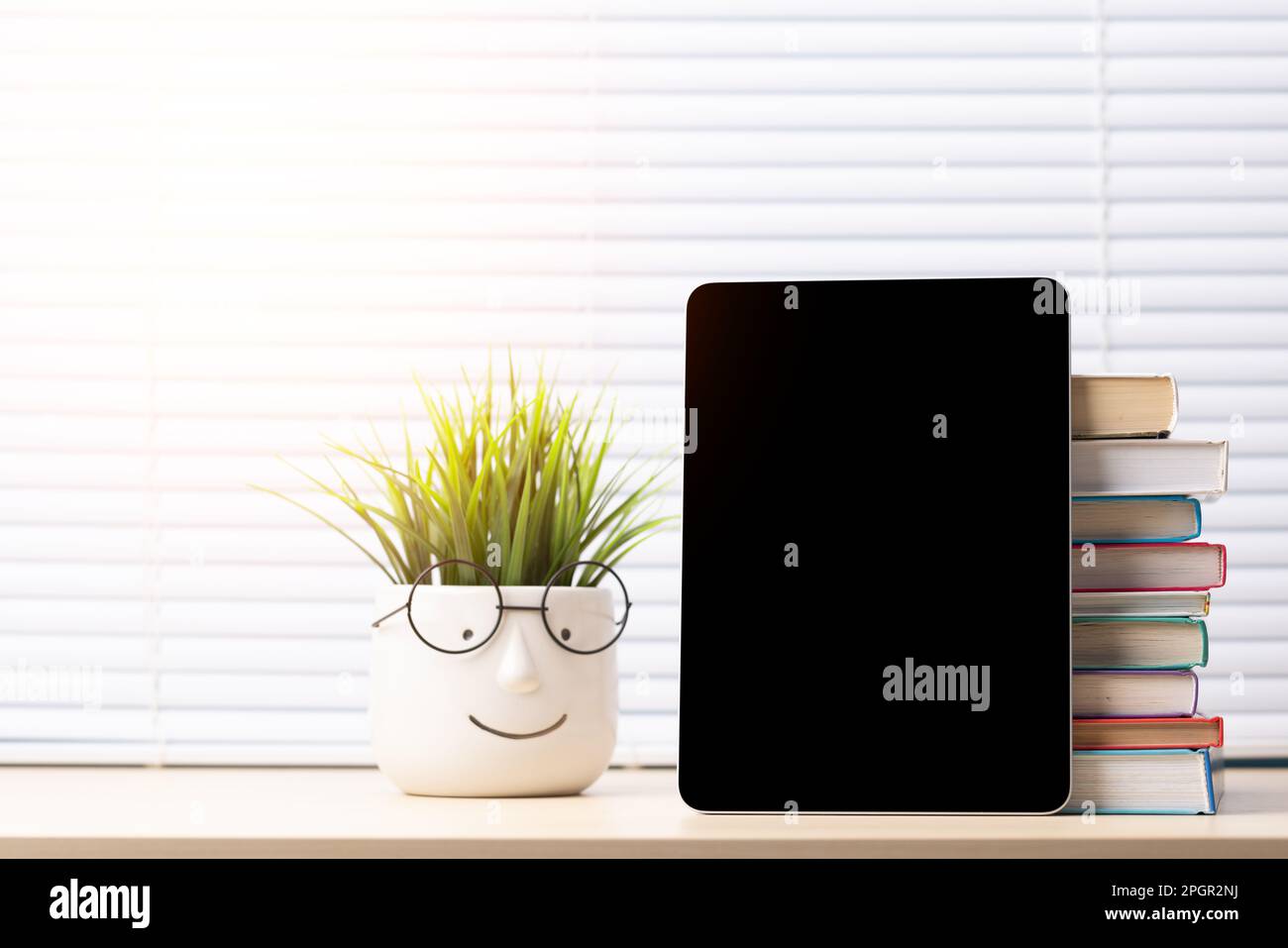 Tablet and stack of books. With blank screen for your text or app Stock ...