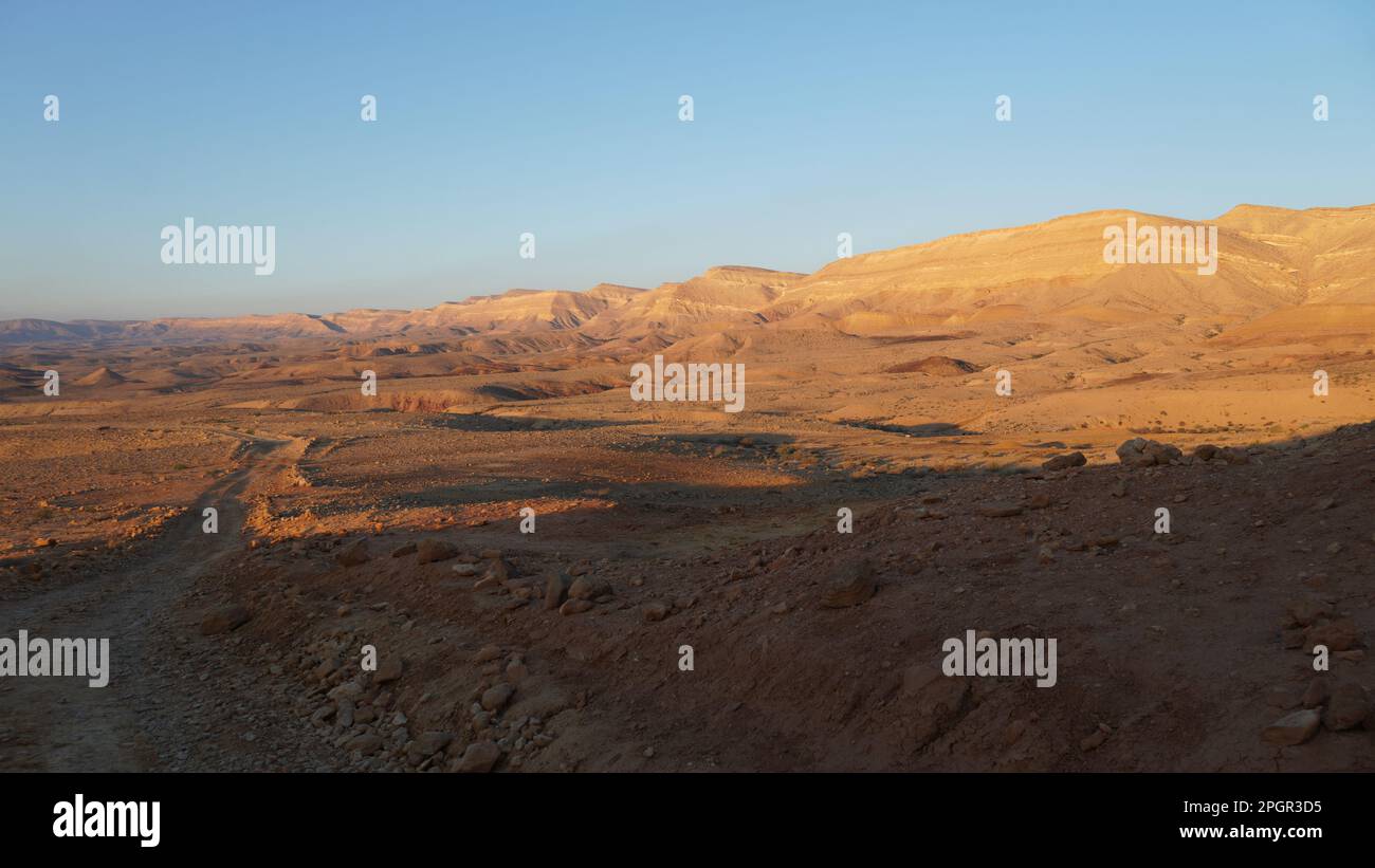 Negev desert landscape at sunrise on the bottom of the crater Makhtesh ...