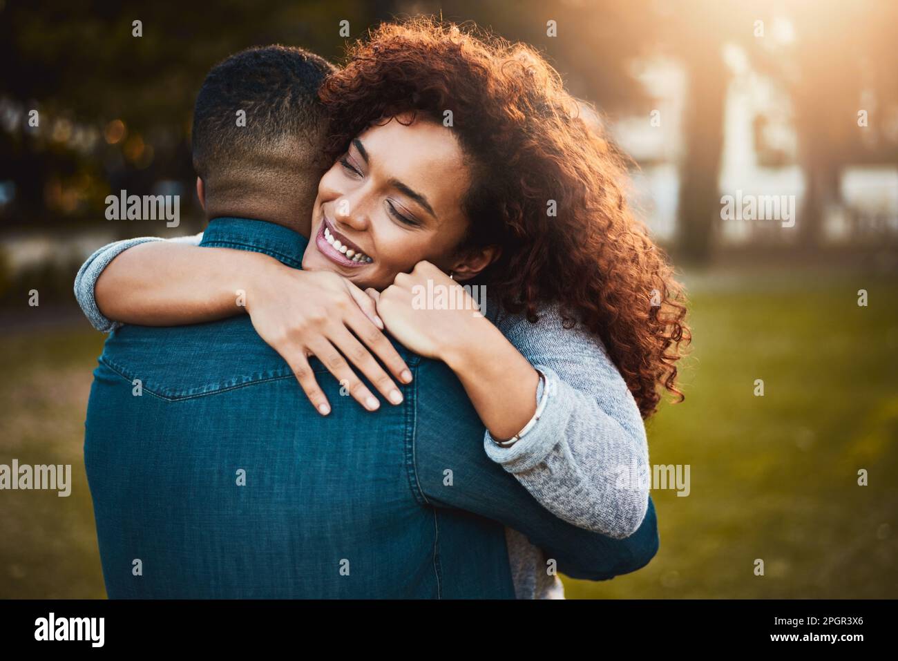 Im the luckiest girl to have a guy like you. a young woman hugging her boyfriend outdoors Stock ...