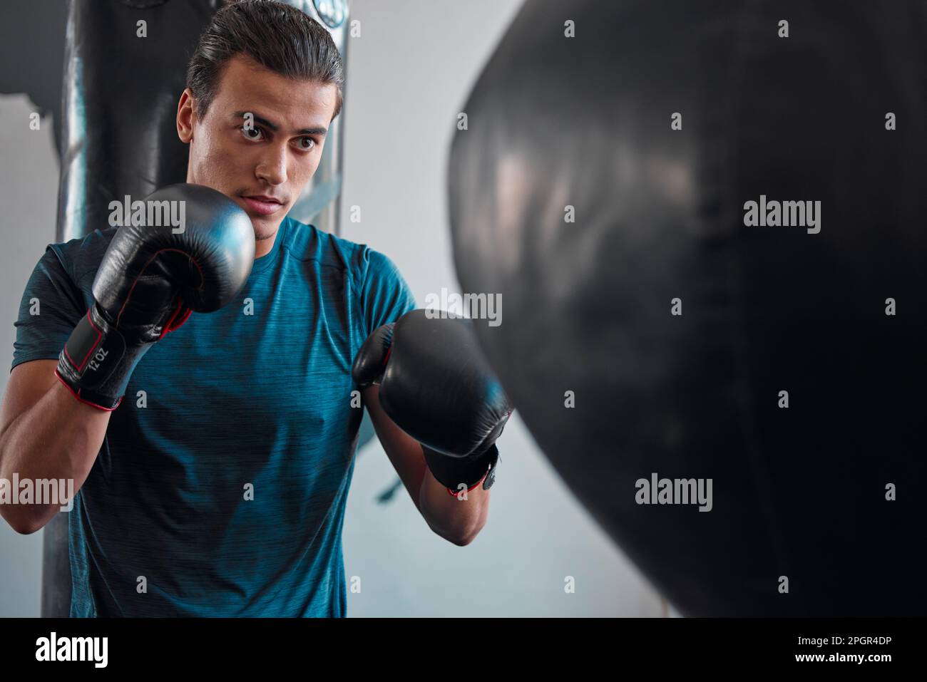 Sports, boxing and man with punching bag in gym for training, exercise ...