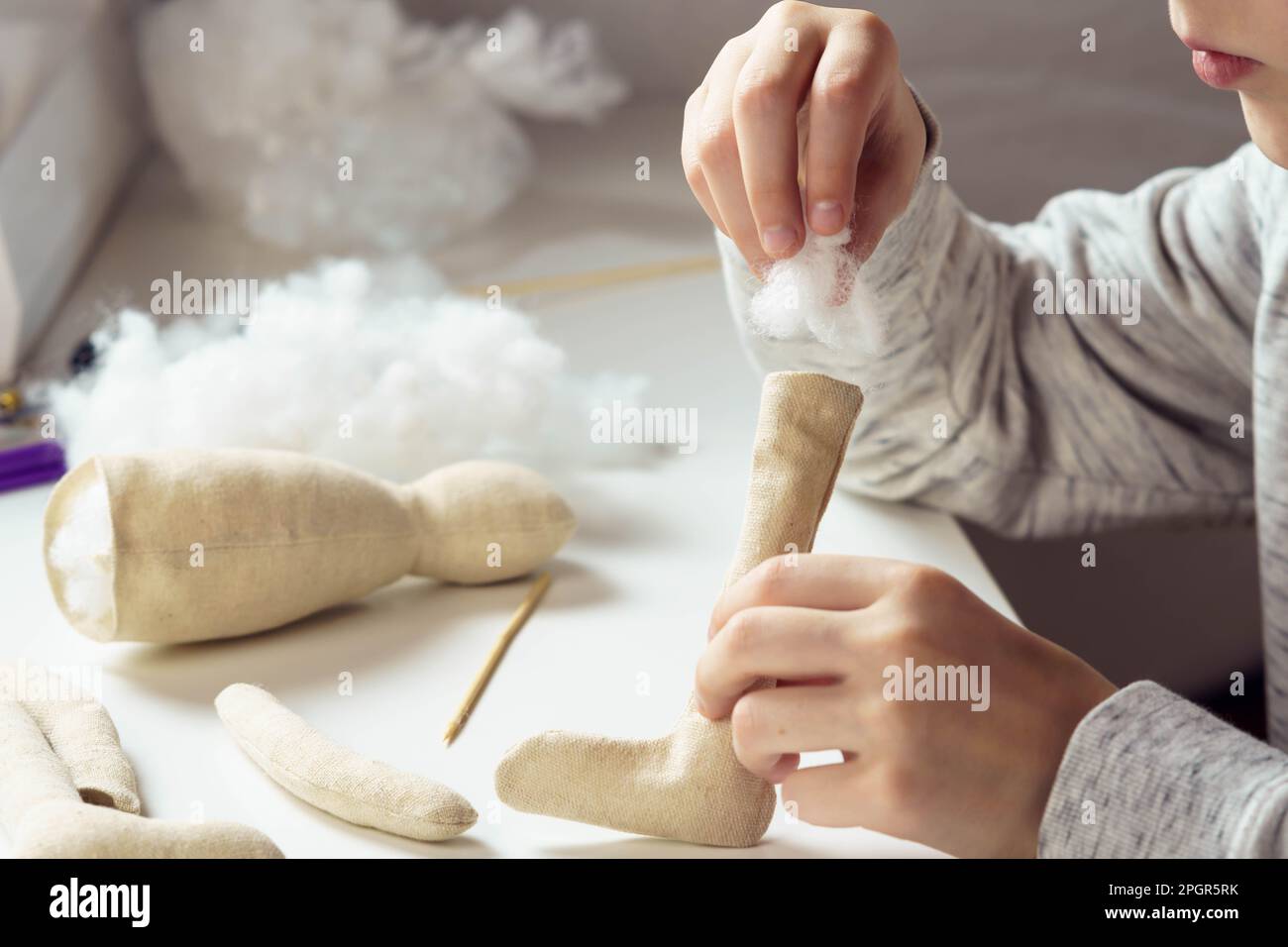 Creating soft stuffed toys with cotton filling. Close up of ...