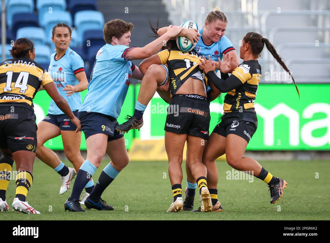 Rosie Ebbage (C) from the Waratahs is tackled by Saelua Leaula (R) and ...