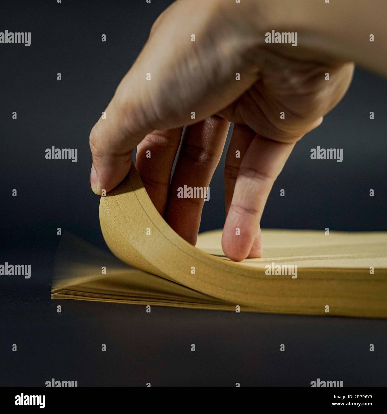 Stack of brown colored paper with hand on frame Stock Photo - Alamy