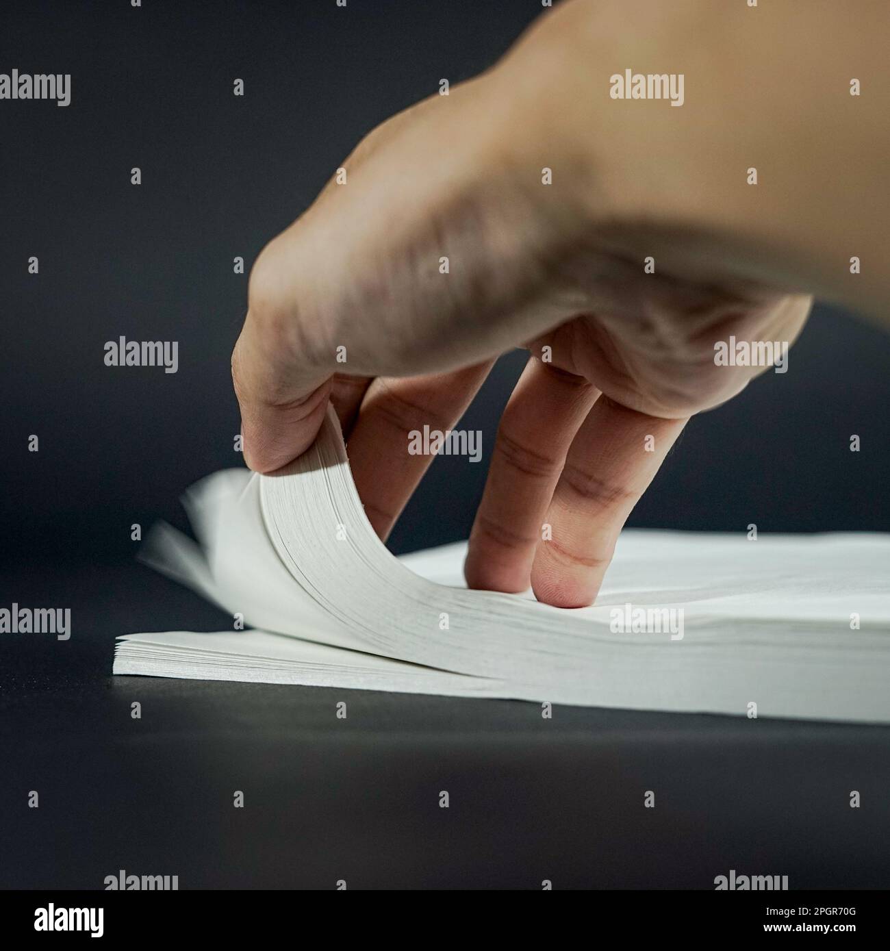 Stack of white colored paper with hand on frame Stock Photo - Alamy