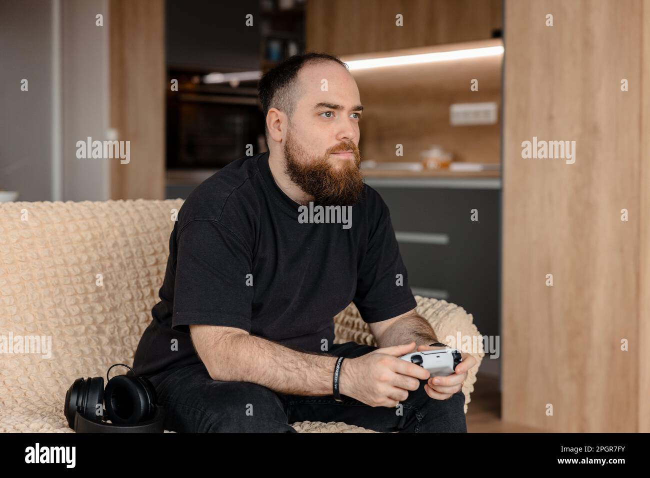 Male gamer playing on console in his home Stock Photo - Alamy