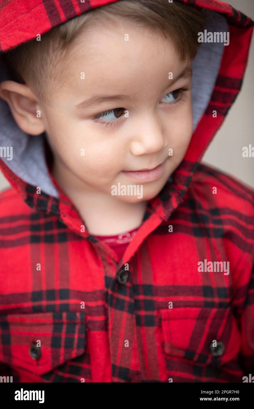 little hooded boy looking away outdoors Stock Photo - Alamy