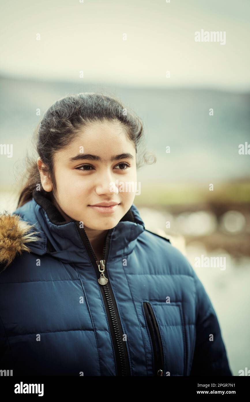 Beautiful teenage girl looking away outdoors Stock Photo - Alamy