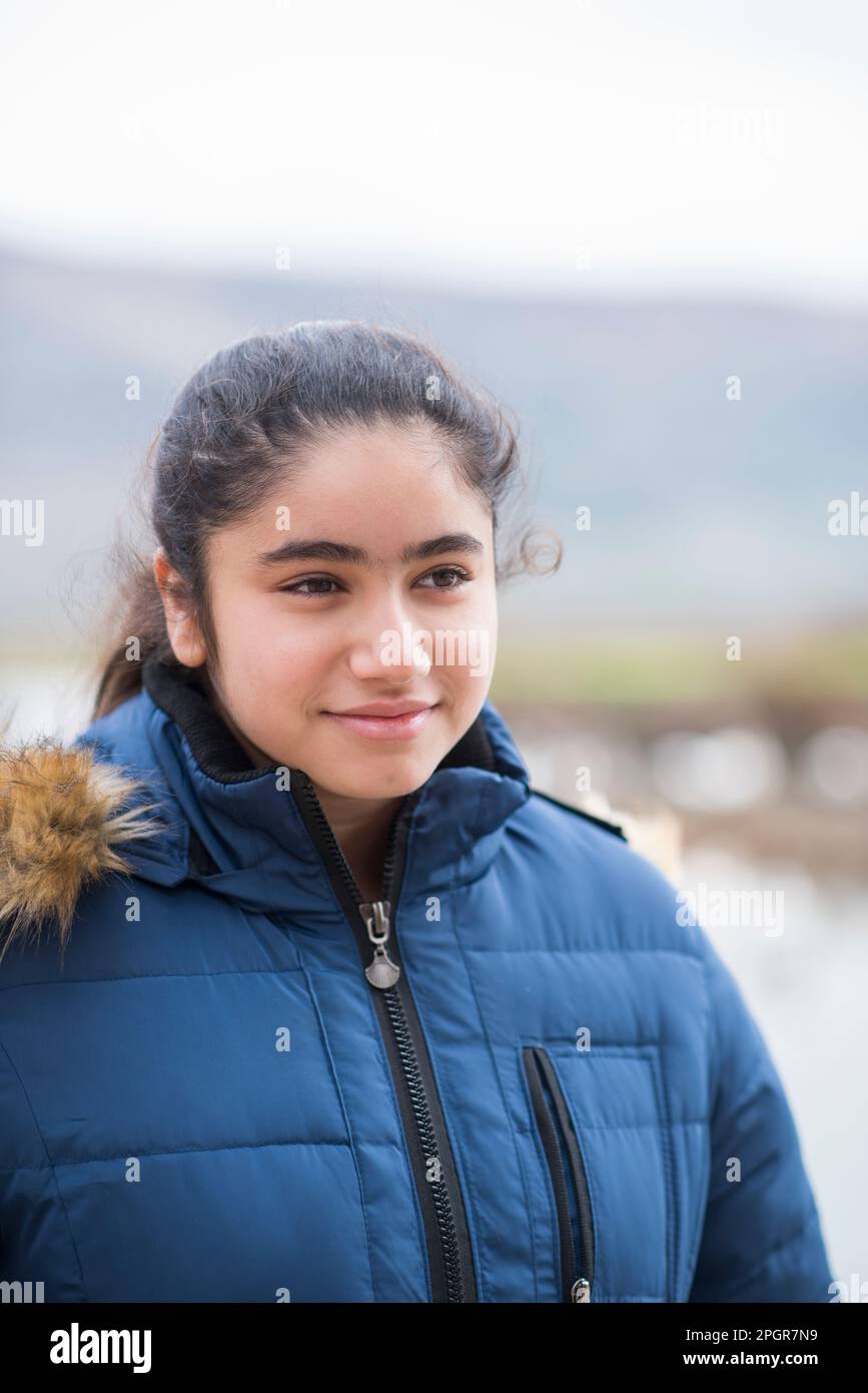 Beautiful teenage girl looking away outdoors Stock Photo - Alamy